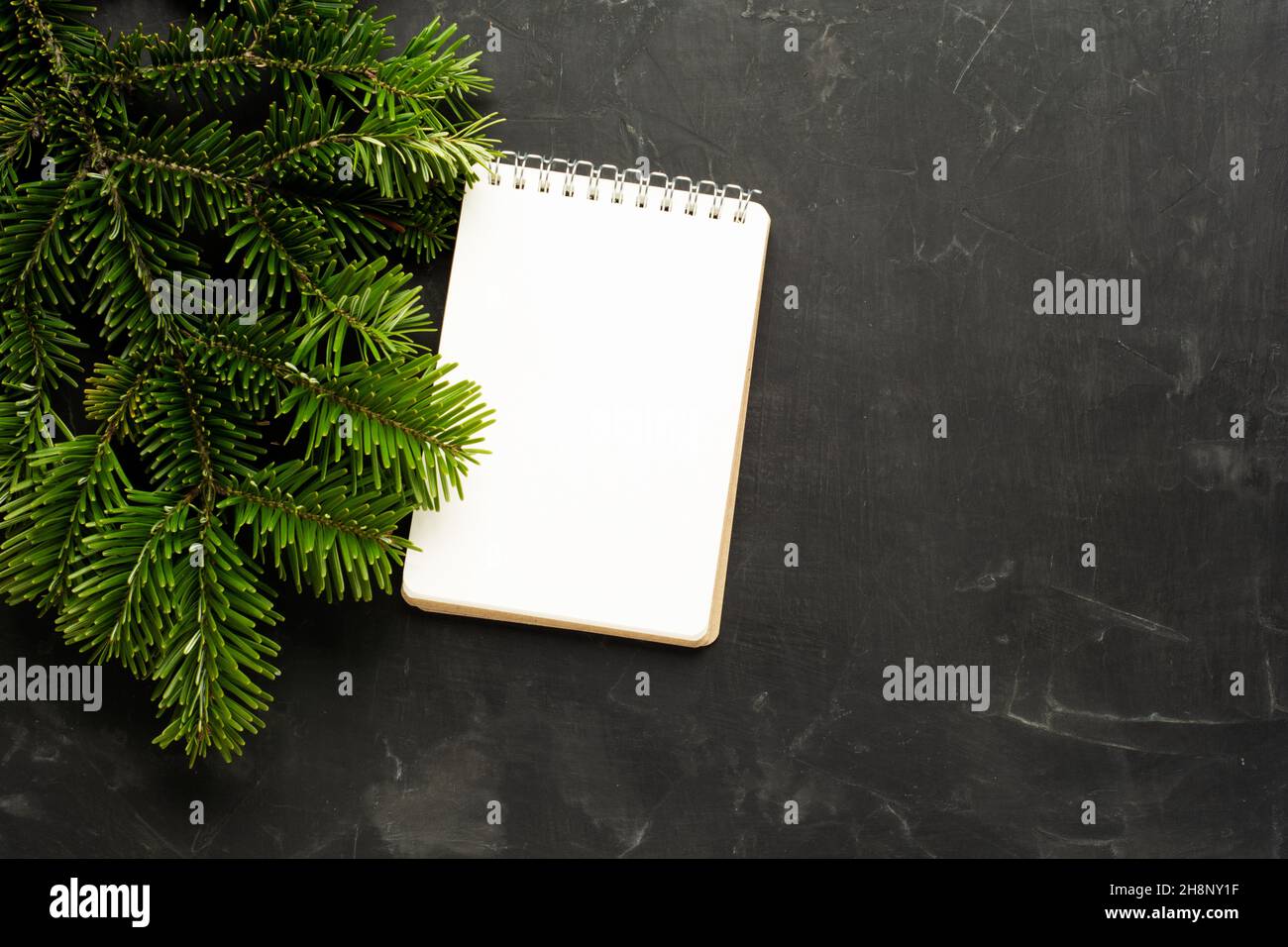 Christmas tree background close up with blank notepad Stock Photo - Alamy