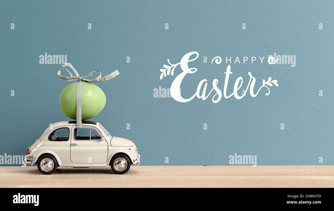 Retro car carrying an easter egg on the roof. Happy Easter text Stock ...