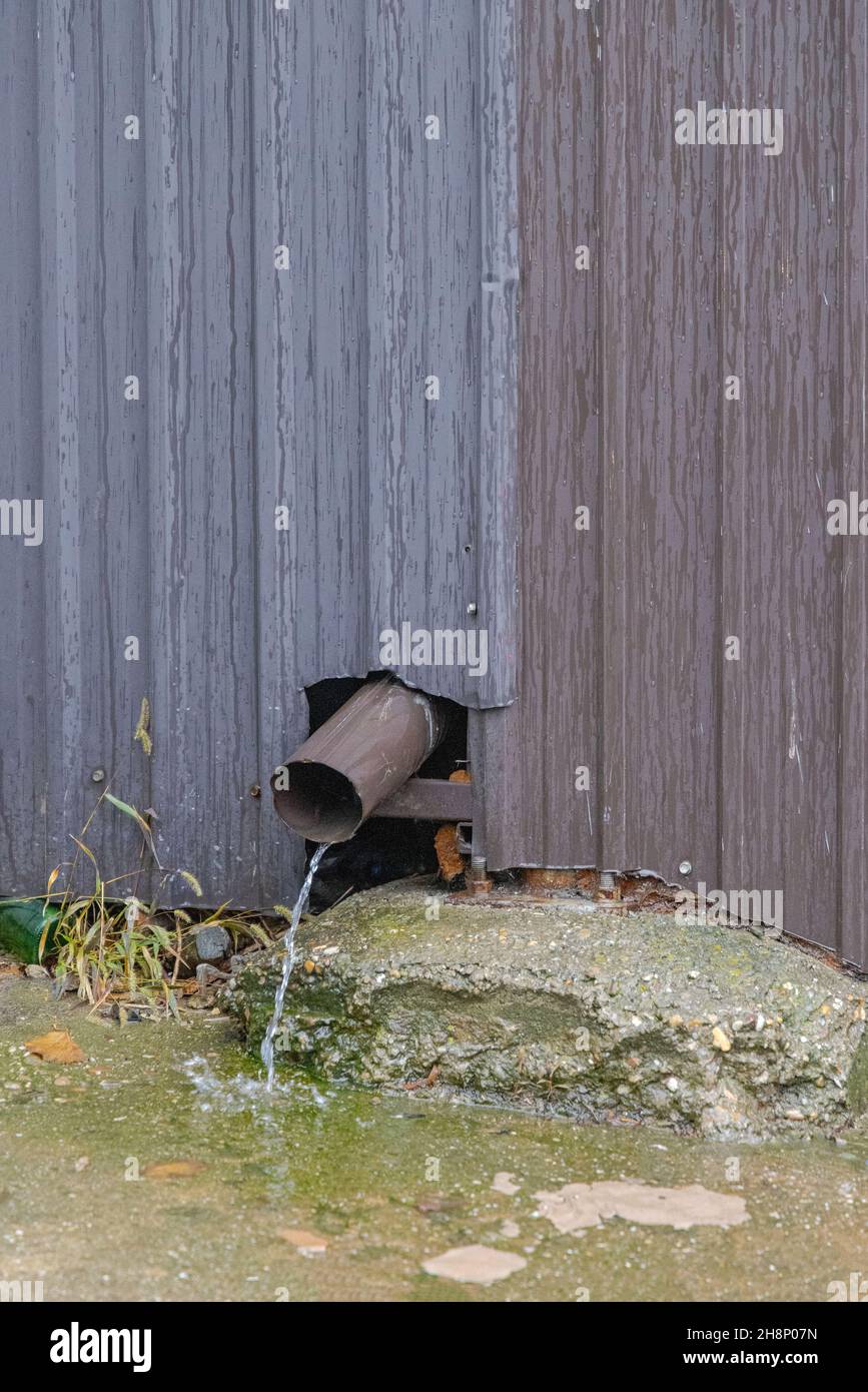 Water Flow From Rain Gutter Pipe at Street Stock Photo - Alamy