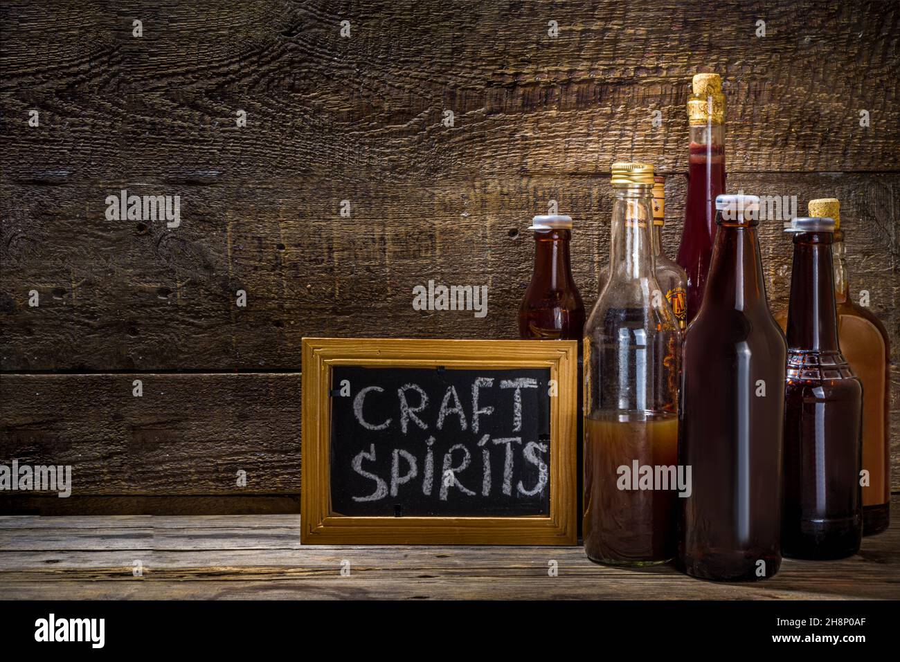 Craft spirit alcohol. Various bottles and glass with hand crafted hard ...