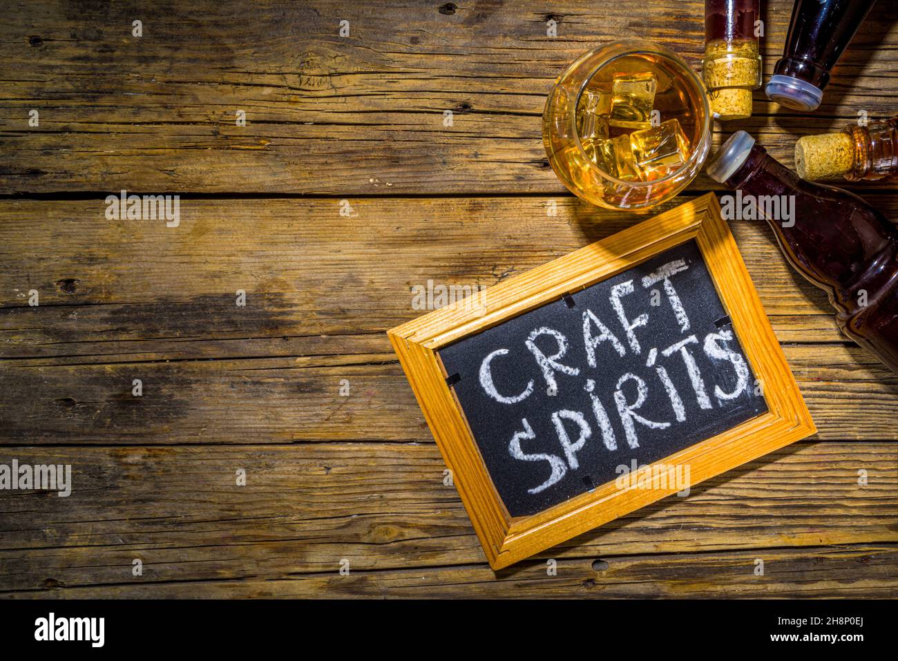 Craft spirit alcohol. Various bottles and glass with hand crafted hard ...
