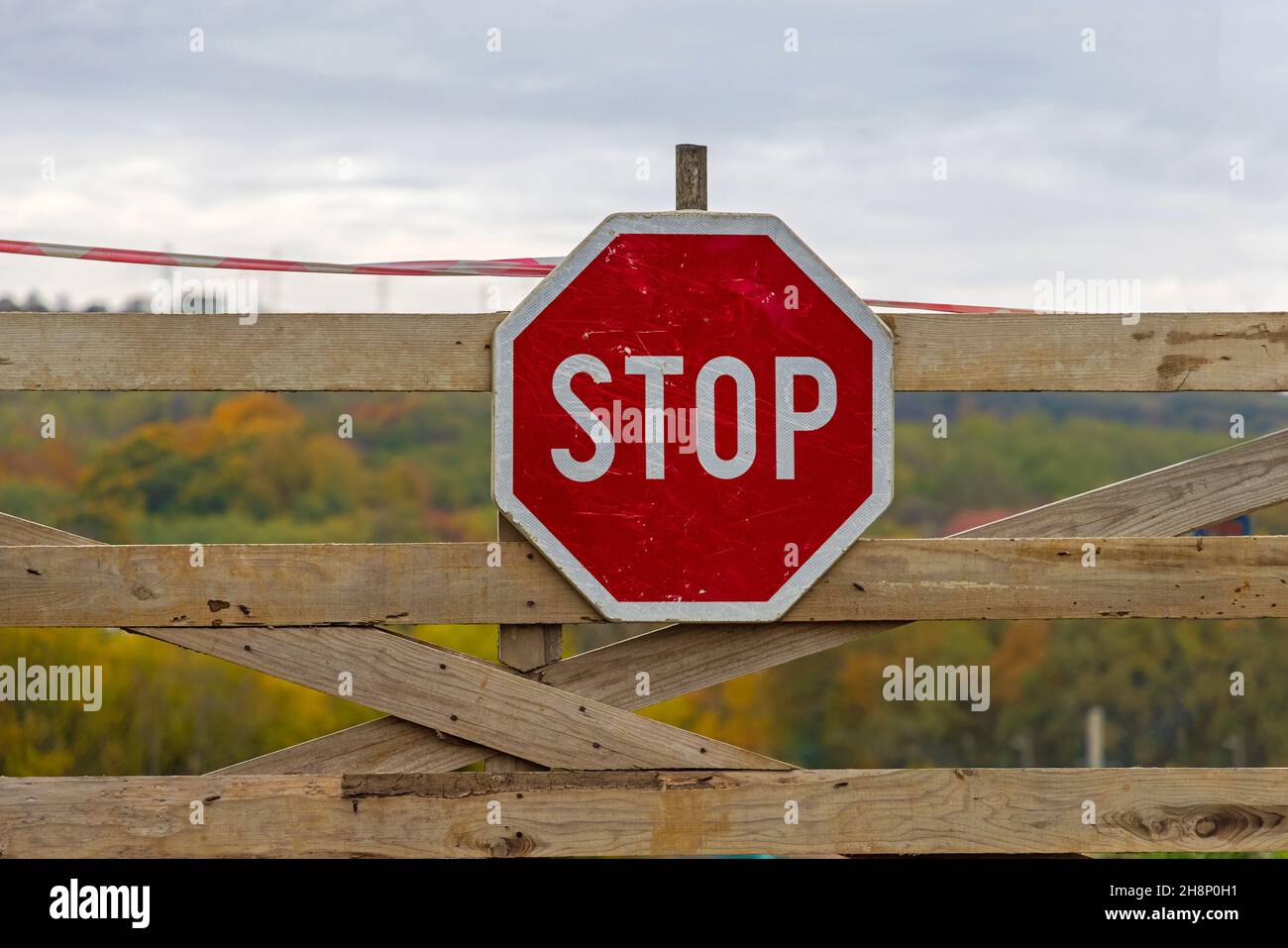 Stop Sign at Wooden Fence Dirt Road Stock Photo - Alamy