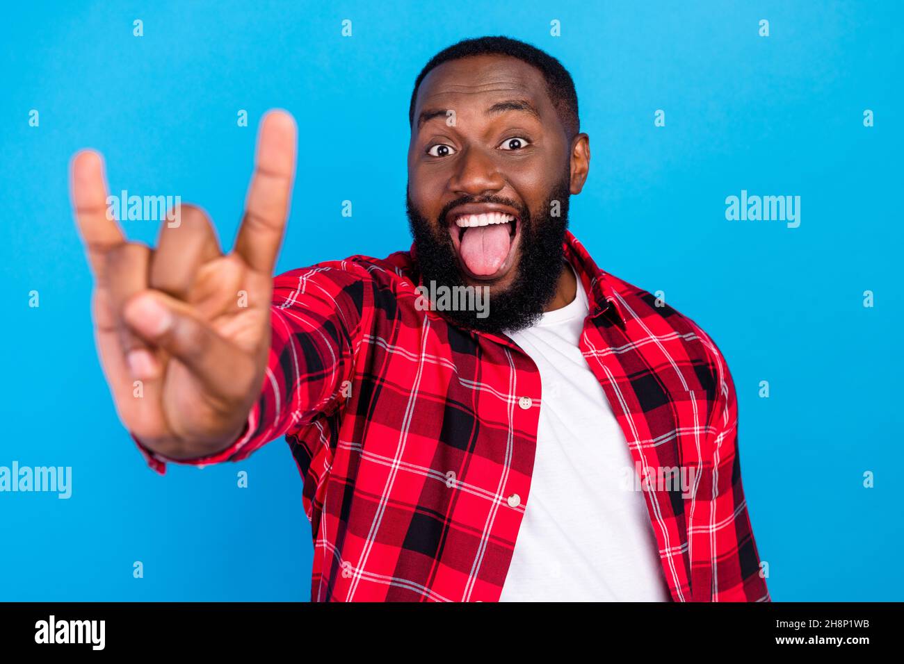 Photo of crazy millennial brunet guy show rock sign wear red shirt ...