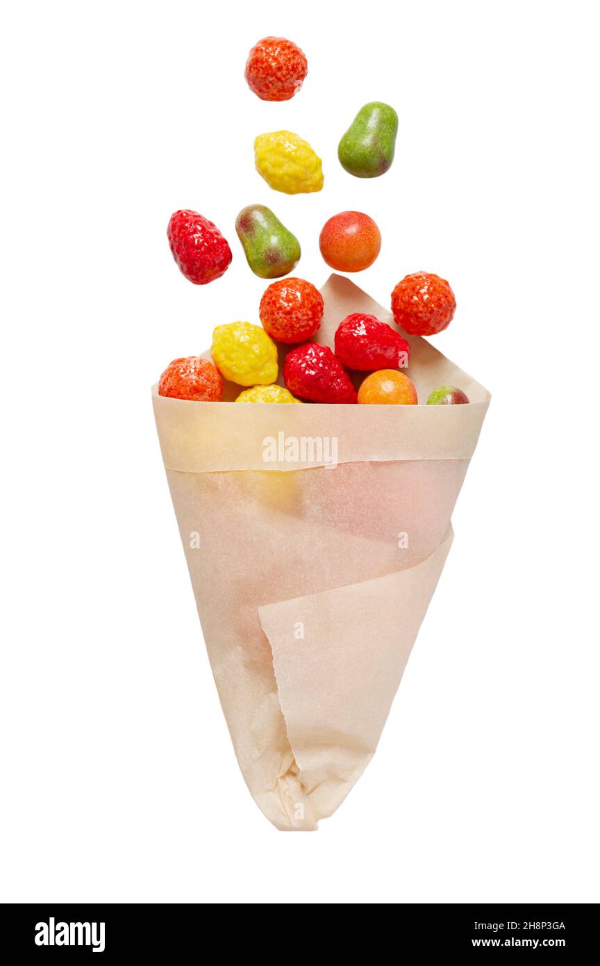 Fruit gummy candies in a paper bag isolated on white background ...