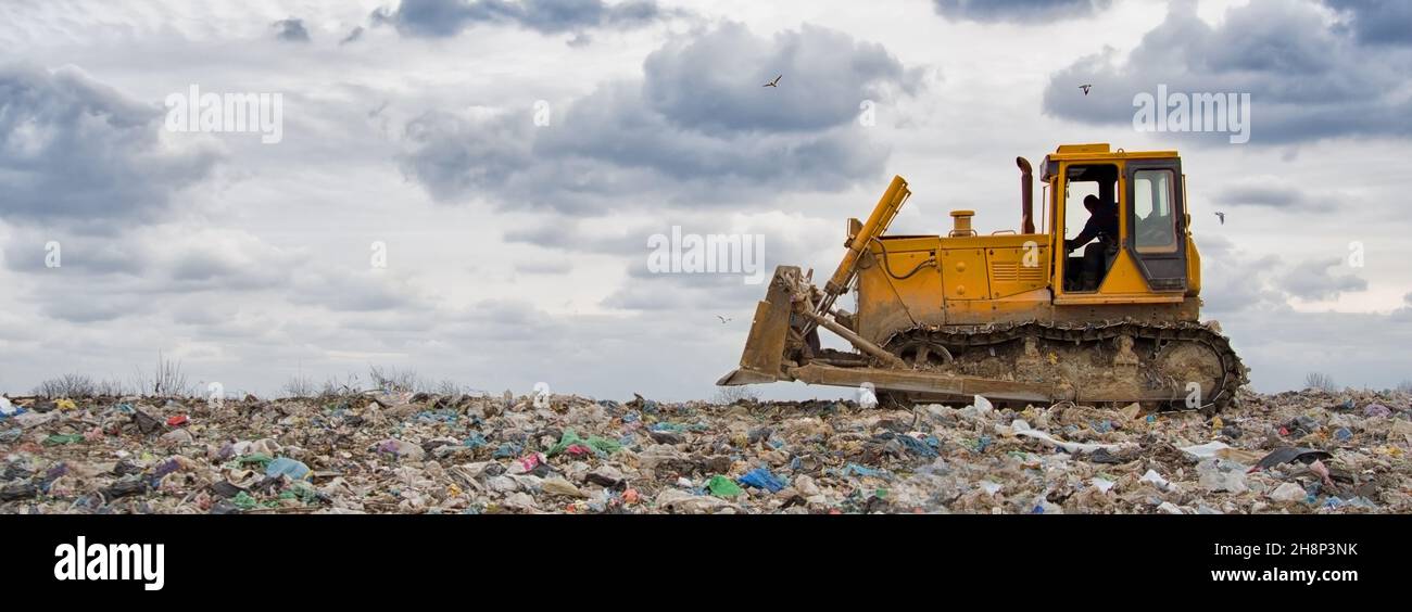 bulldozer working on landfill with birds in the sky (panorama Stock ...
