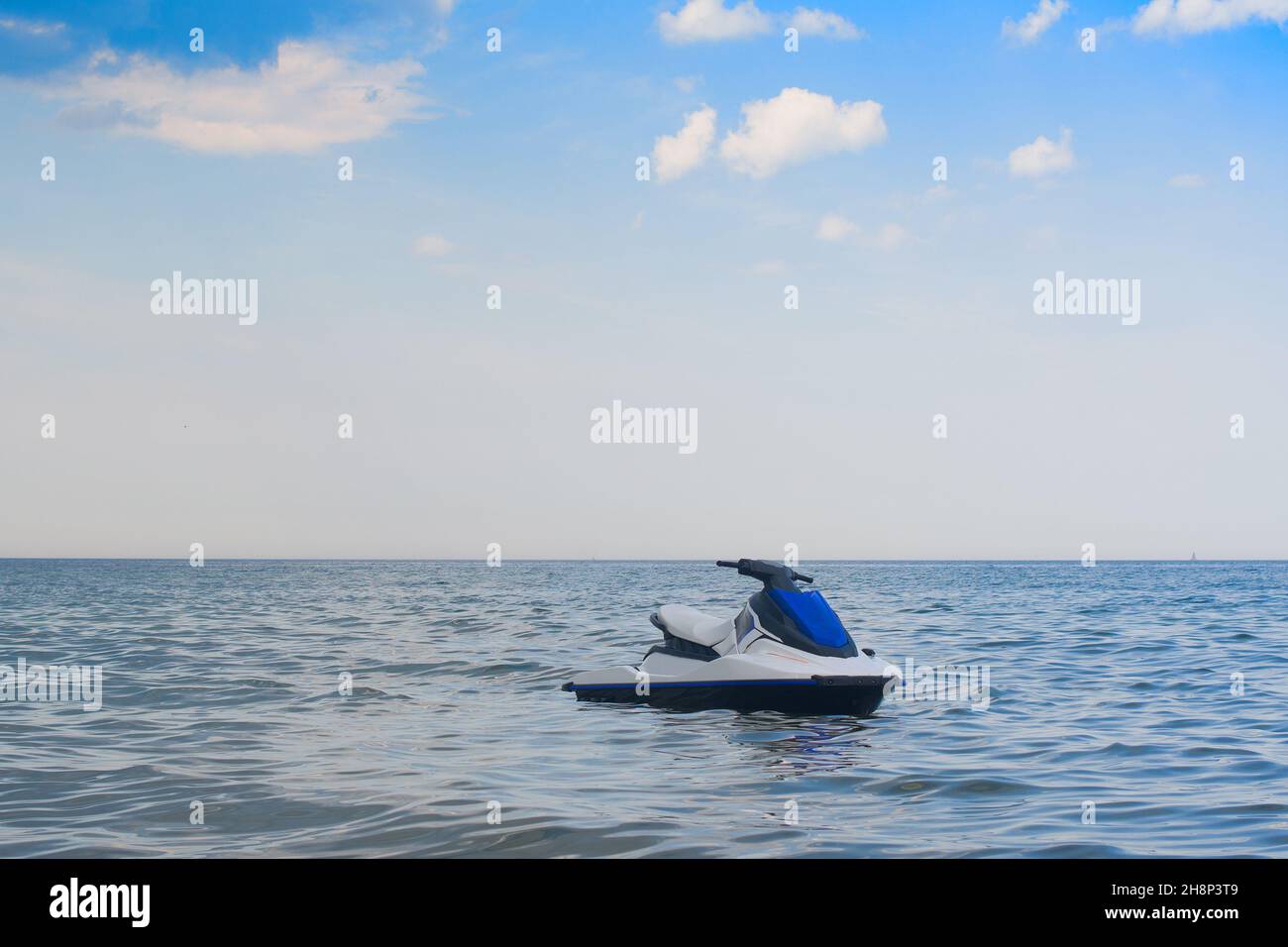Blue sea and a jet ski floating on sea Stock Photo - Alamy