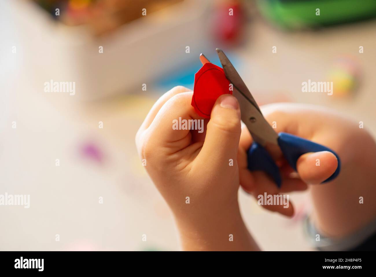 Boy Cuts out Figure with Scissors Stock Photo - Alamy