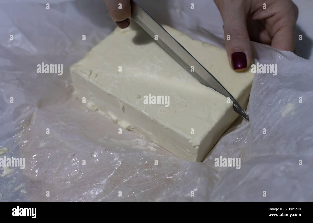 a large piece of butter cut with a knife. High quality photo Stock ...