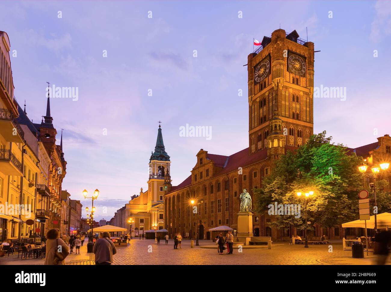 Torun Town Hall and monument of Copernicus at night Stock Photo - Alamy