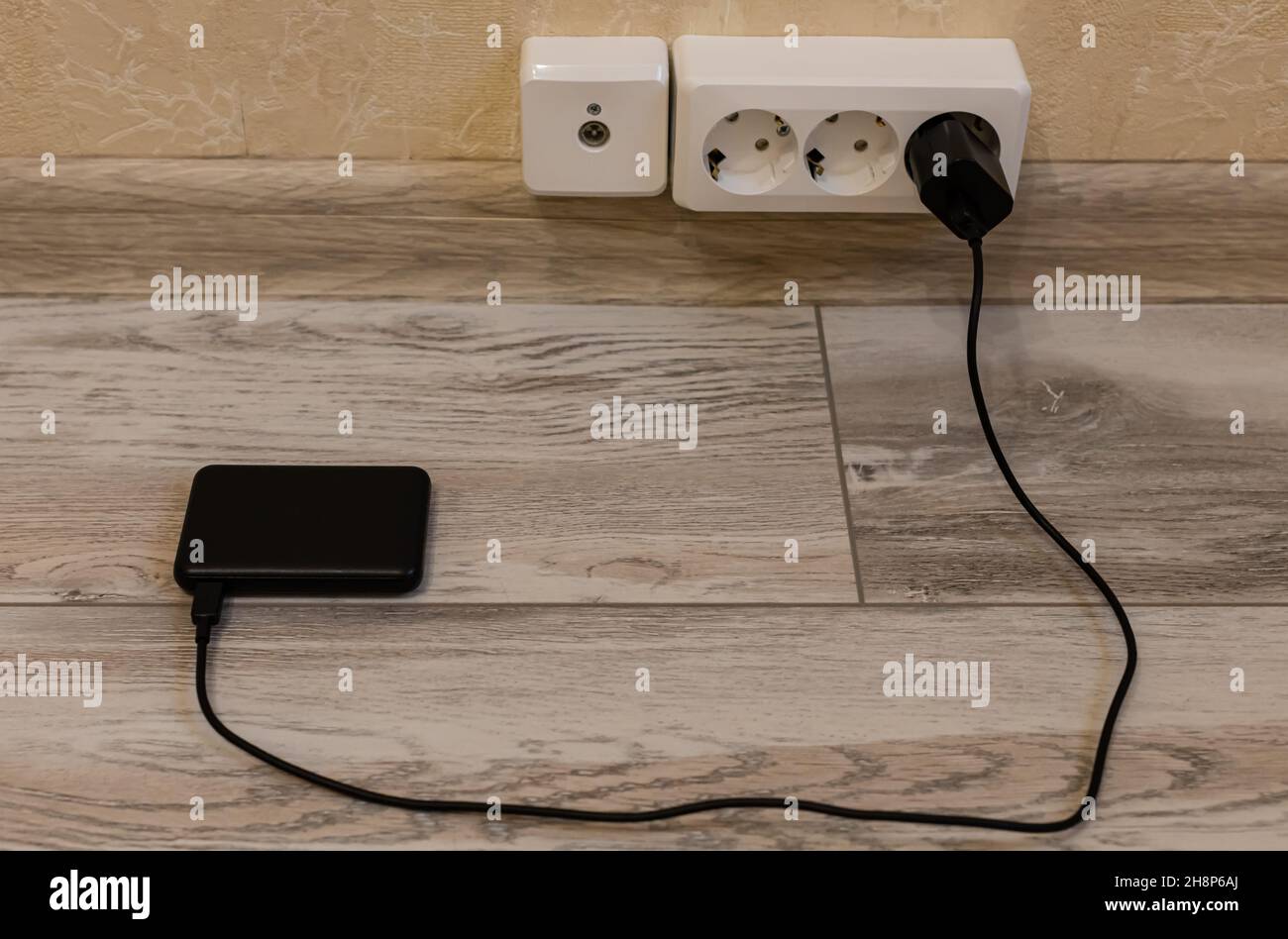 the external battery is charged from a socket lying on the floor. High ...