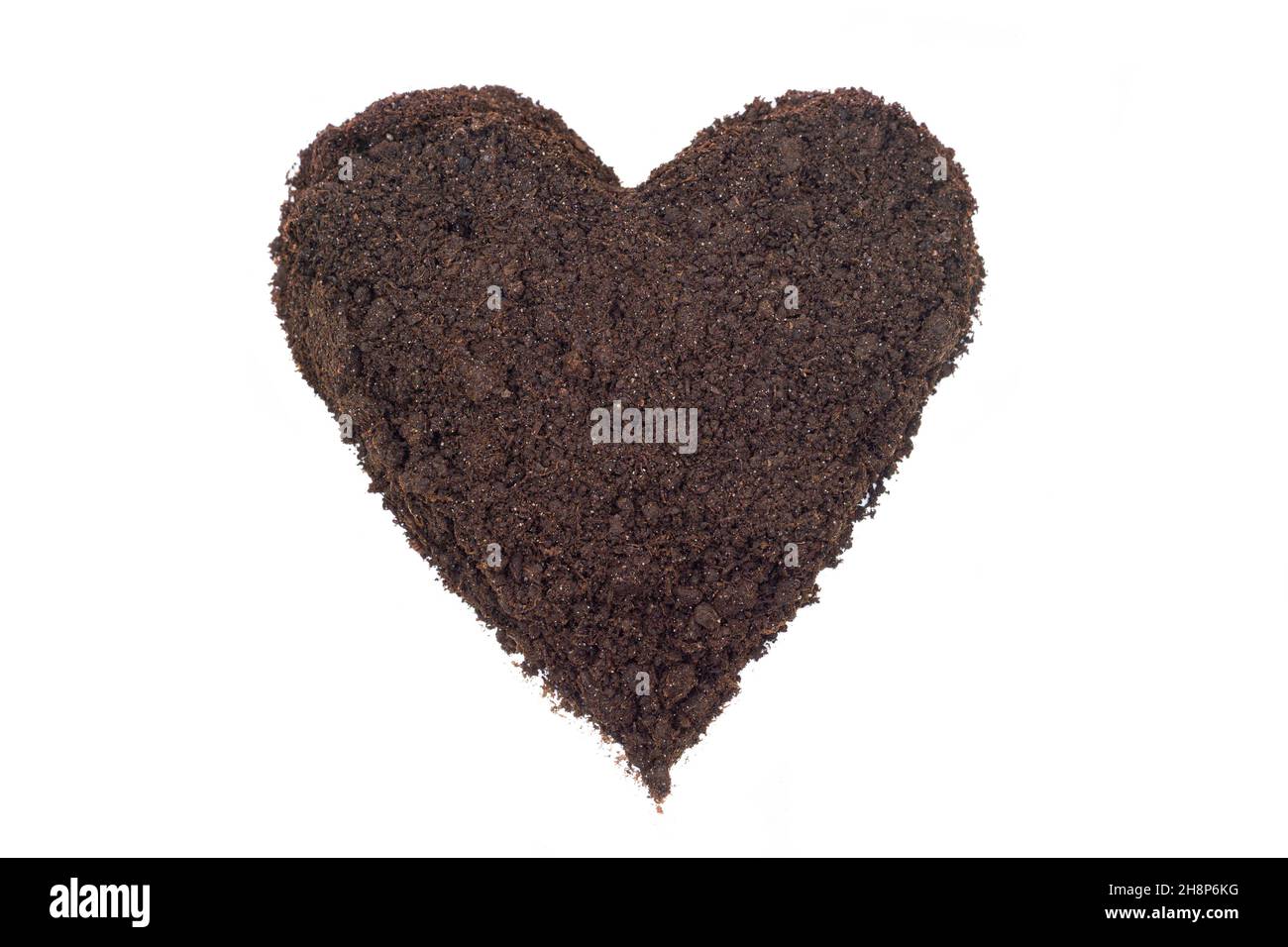 Soil shaped into a heart symbol isolated on white background. Creating ...