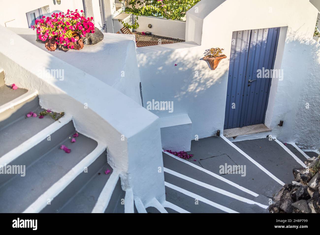 Entrance of a typical White cycladic architecture, house with blue door ...