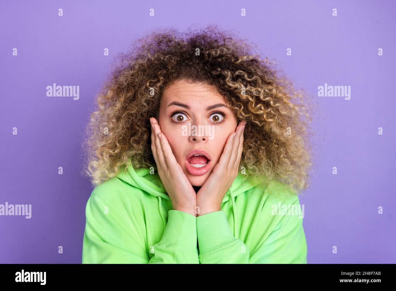 Photo Of Shocked Lady Dressed Green Hoodie Open Mouth Arms Cheeks