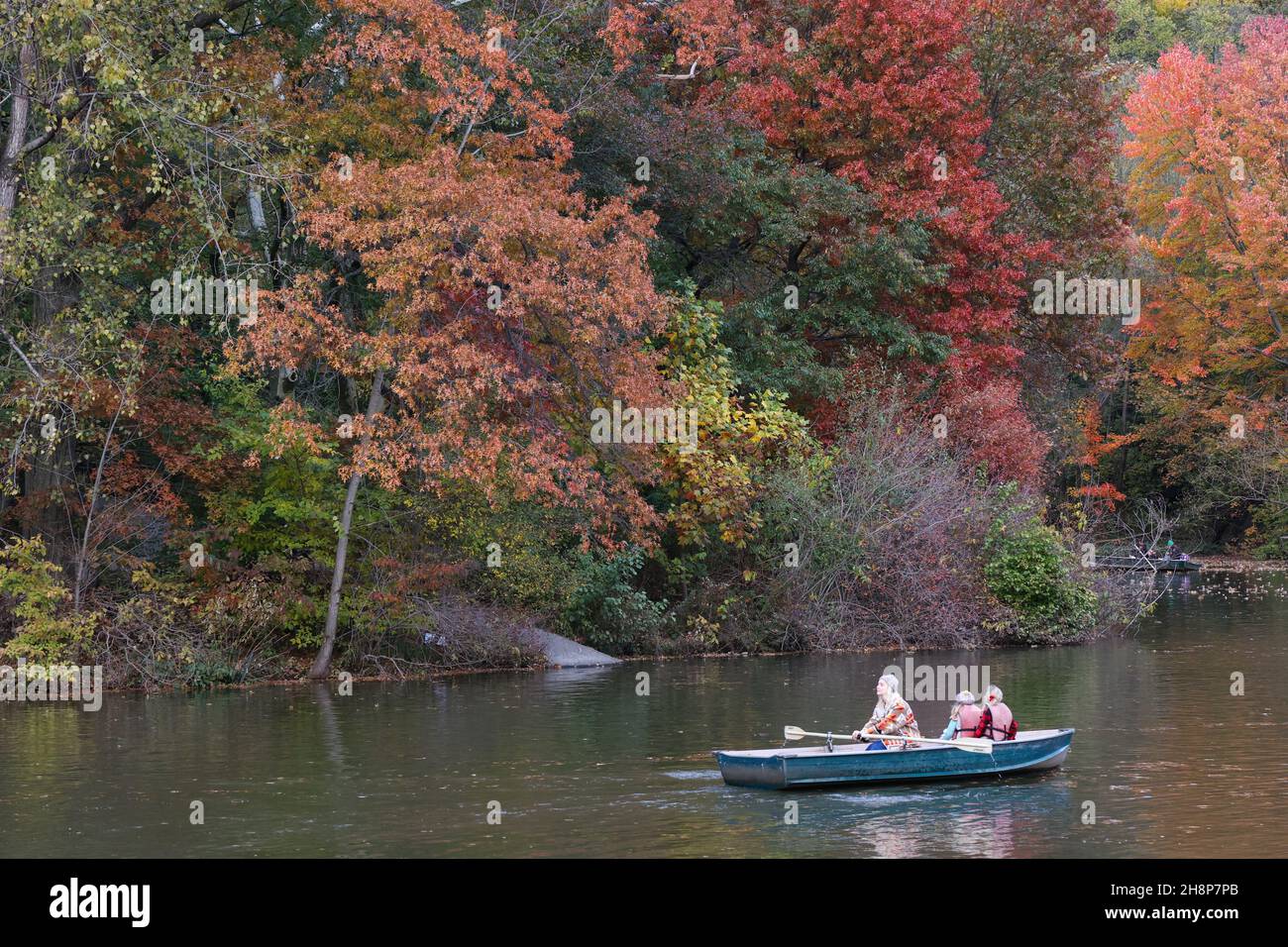 Single mother and children row a boat in Central Park NY Stock Photo ...