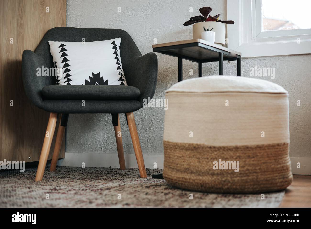 Chair and Ottoman in office Space with Natural Light Stock Photo - Alamy