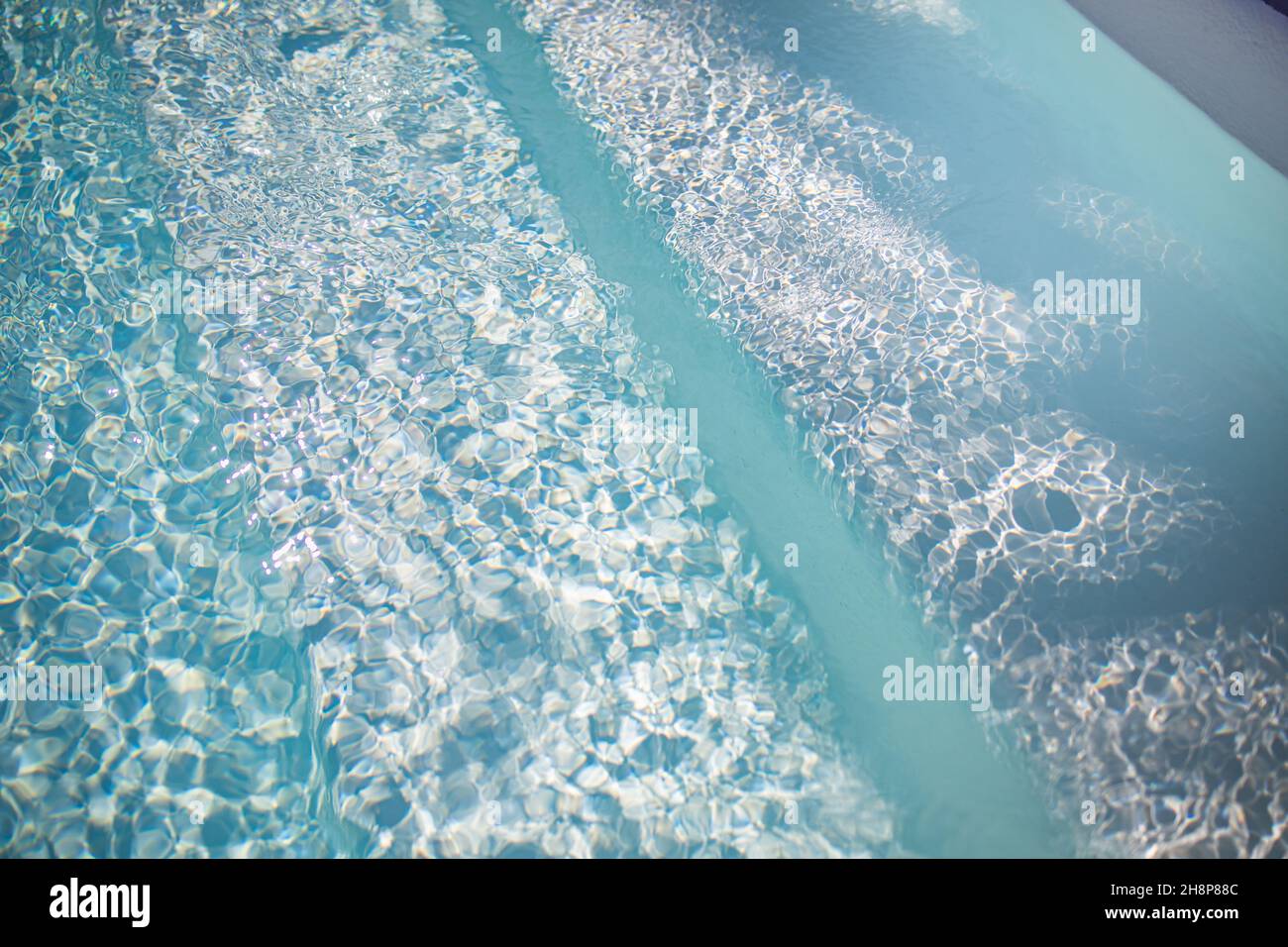 Abstract swimming pool background. Summer relax and recreational concept, blue ripped water with ...