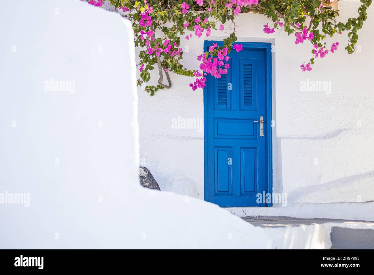 Entrance of a typical White cycladic architecture, house with blue door ...