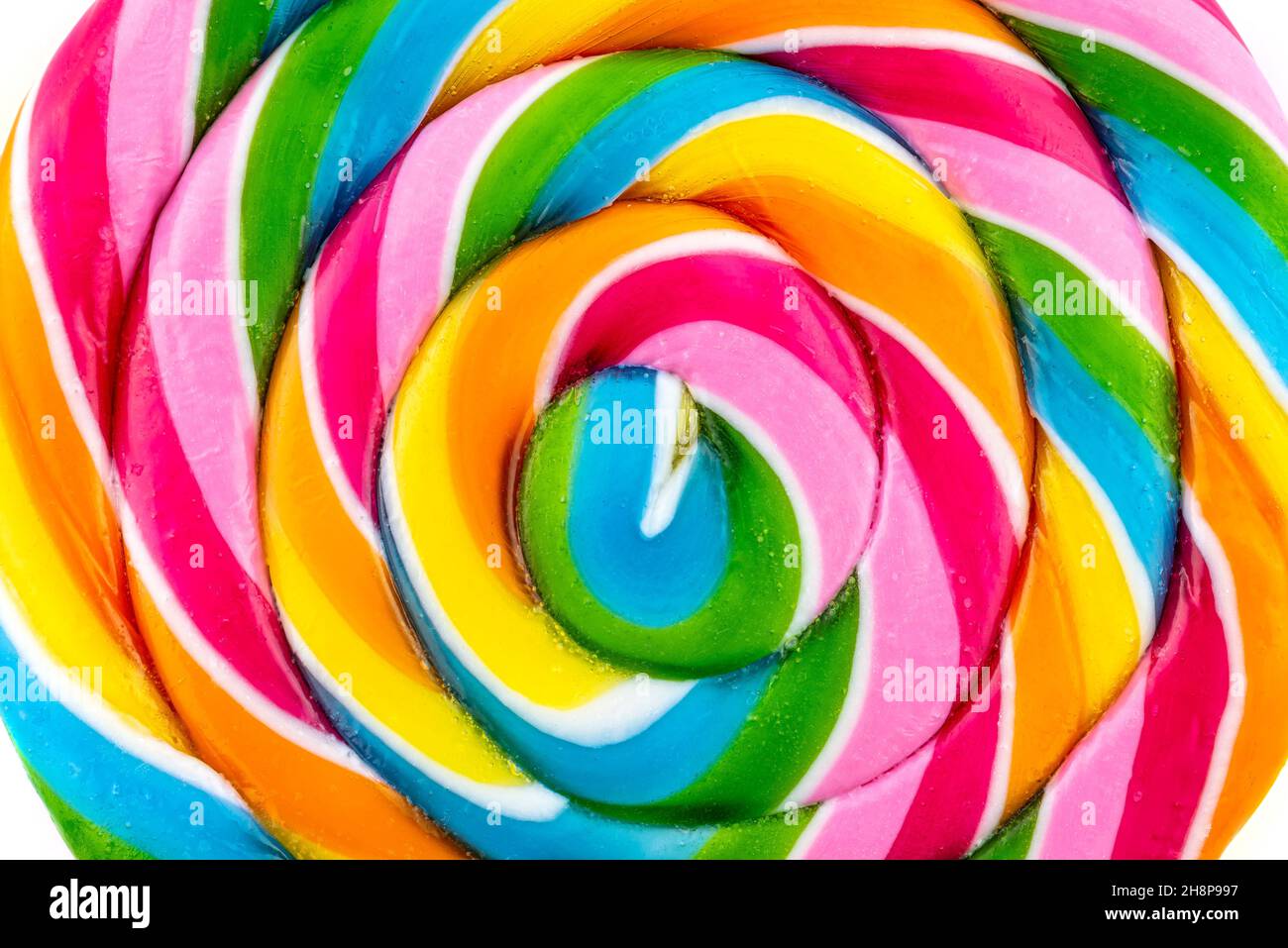 A macro photo of a sweet colorful lollipop in the shape of a spiral ...