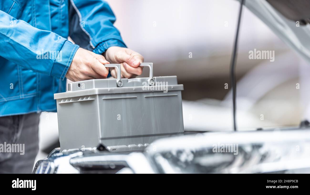 Car mechanic replaces battery hi-res stock photography and images - Alamy