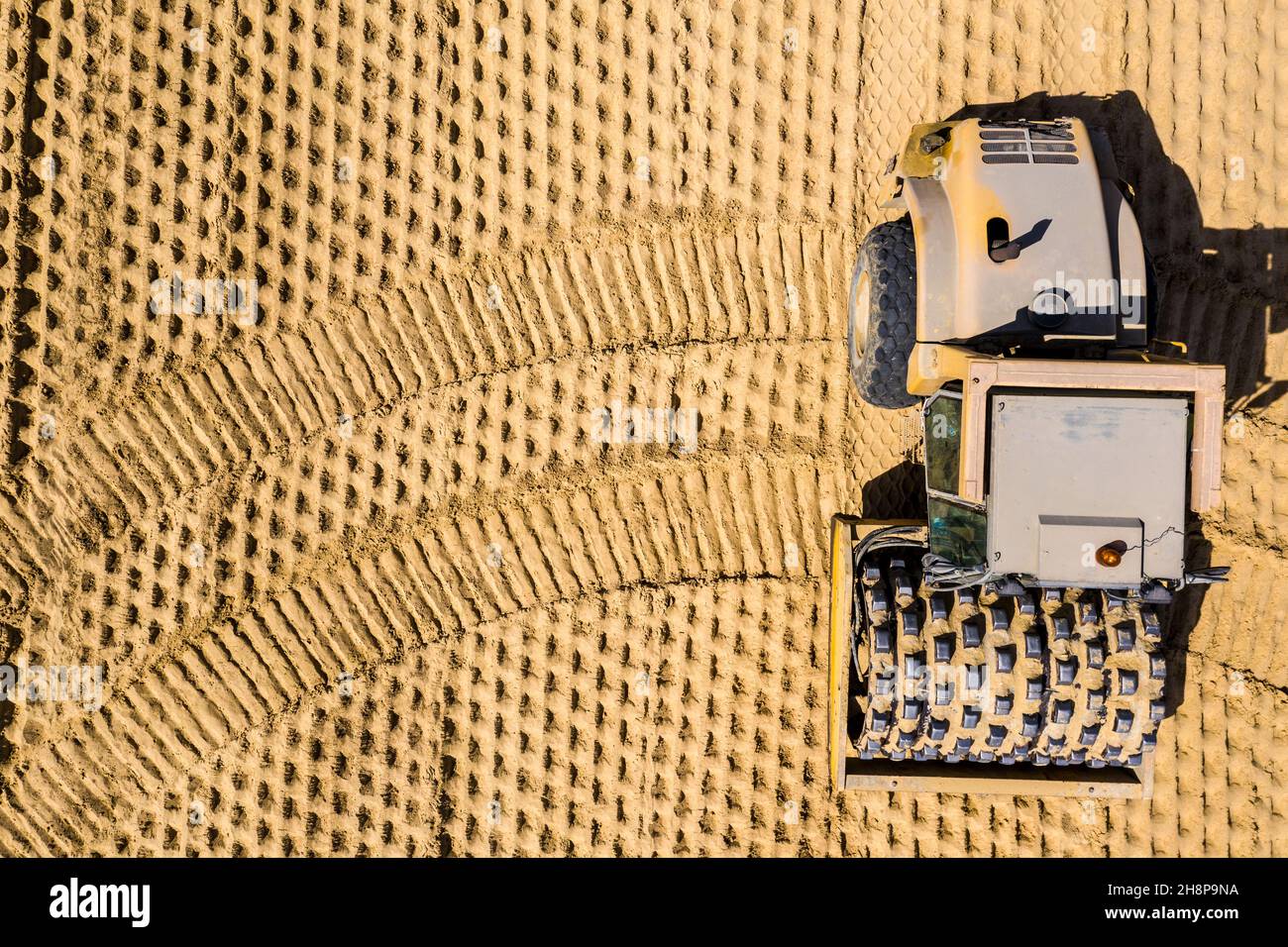 Aerial View. Roller steamroller or vibratory roller machine working on ...