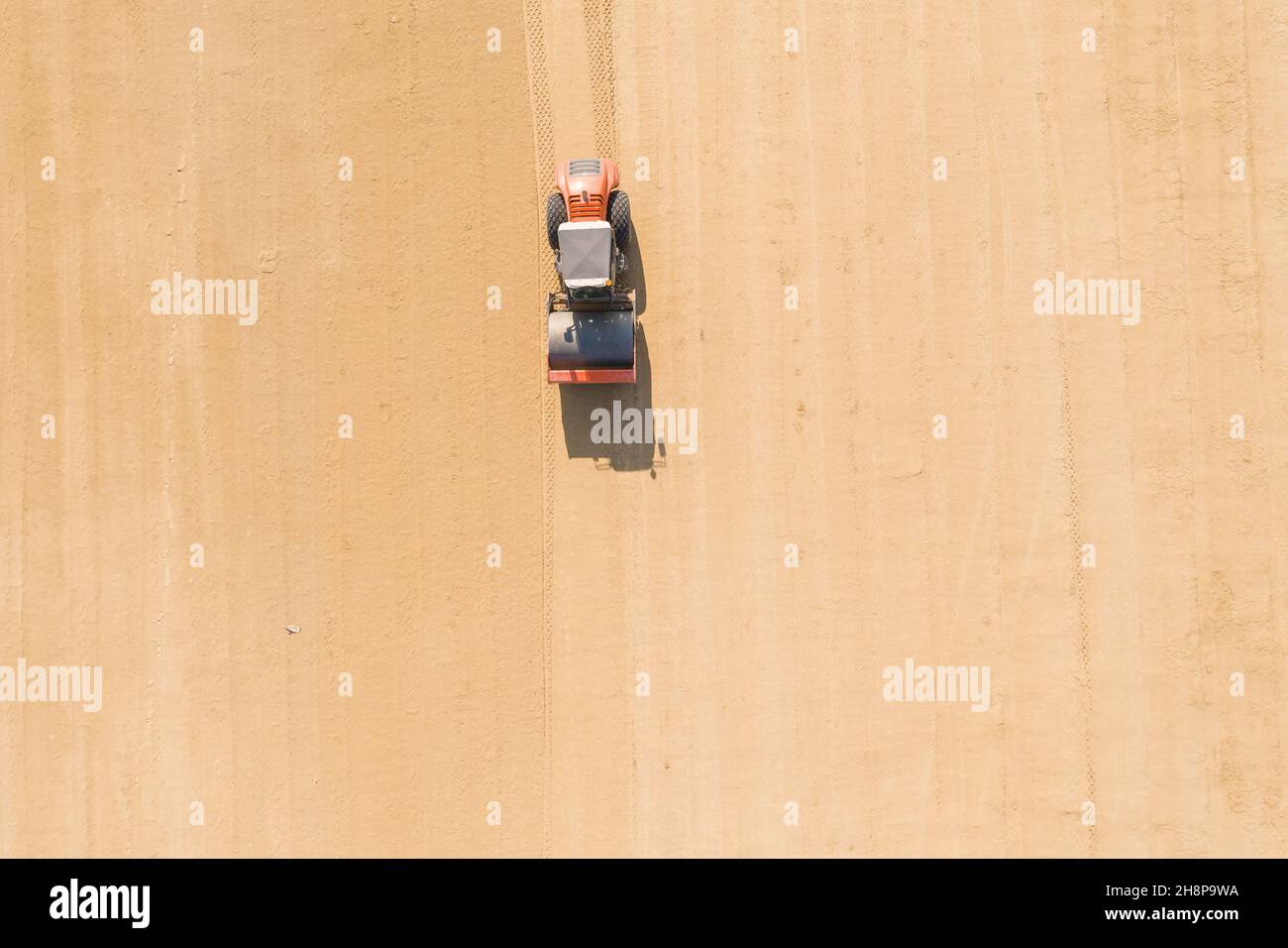 Aerial view of machinery and mine equipment near road on sandy surface ...