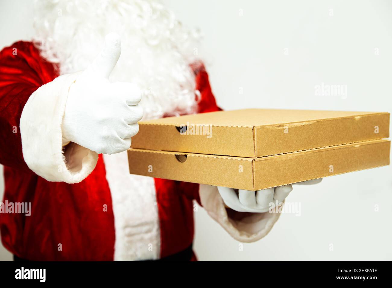Pizza boxes in the hands of Santa Claus. Christmas fast food delivery ...
