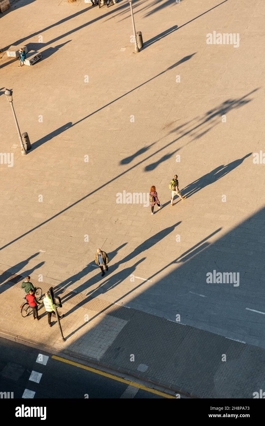 People walking with long shadows Stock Photo - Alamy