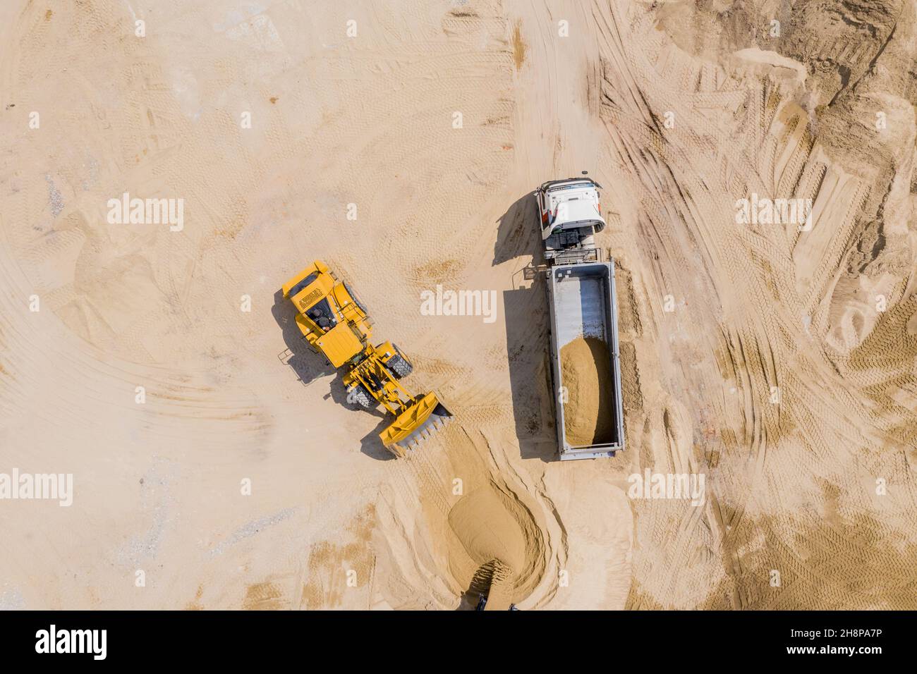 Aerial view of sand quarry with trucks and bulldozers. Heavy bulldozer ...