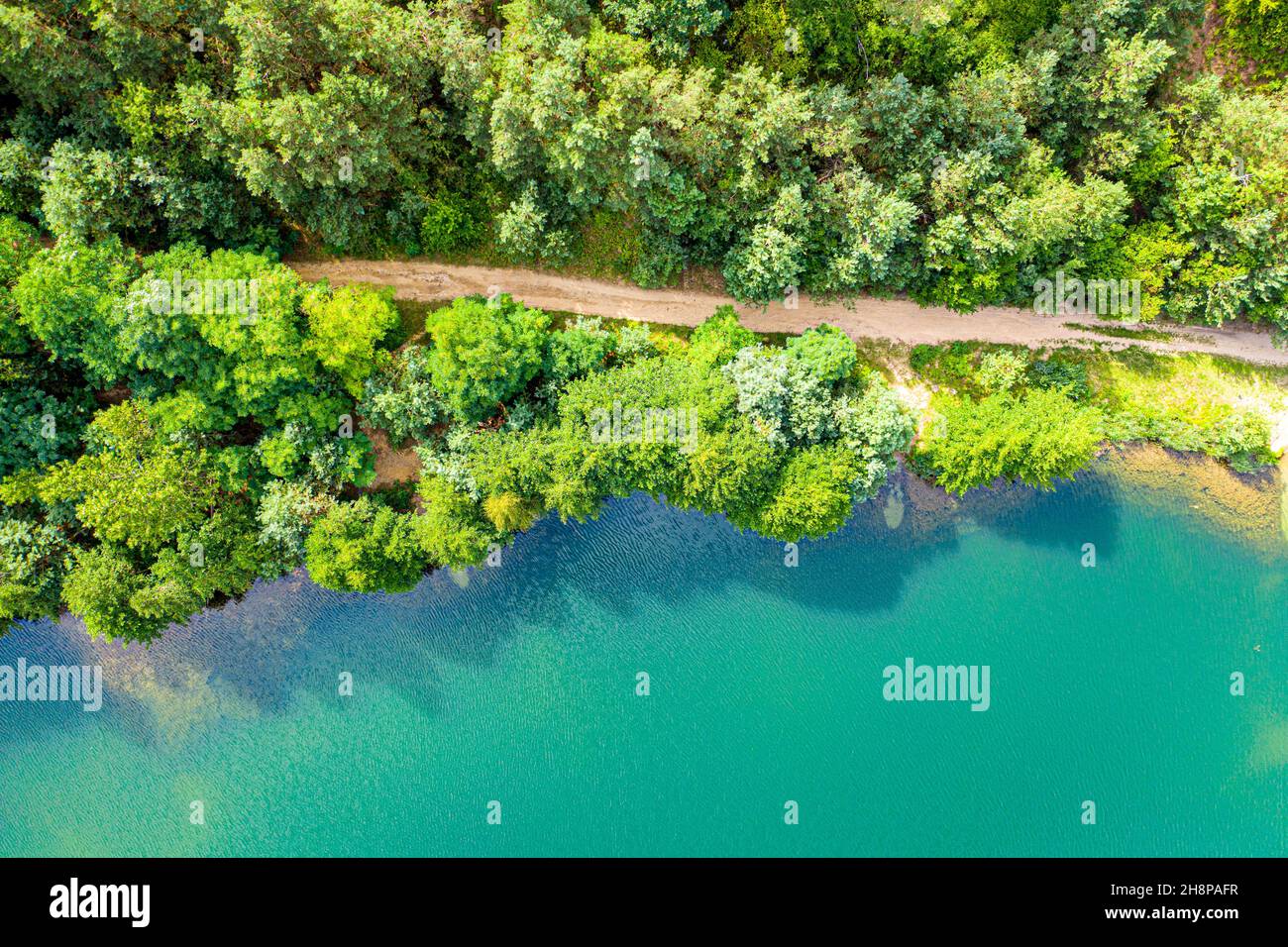 Aerial view of countryside road passing through the green forrest Stock ...