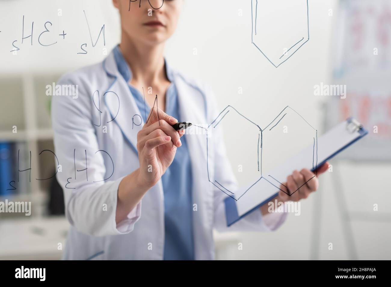 Doctor writing on medical board hi-res stock photography and images - Alamy
