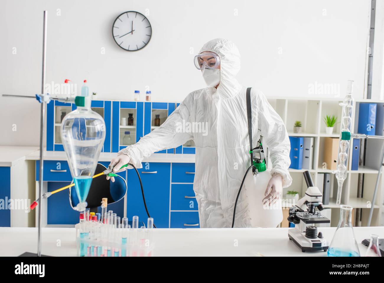 woman in personal protective equipment making disinfection of ...