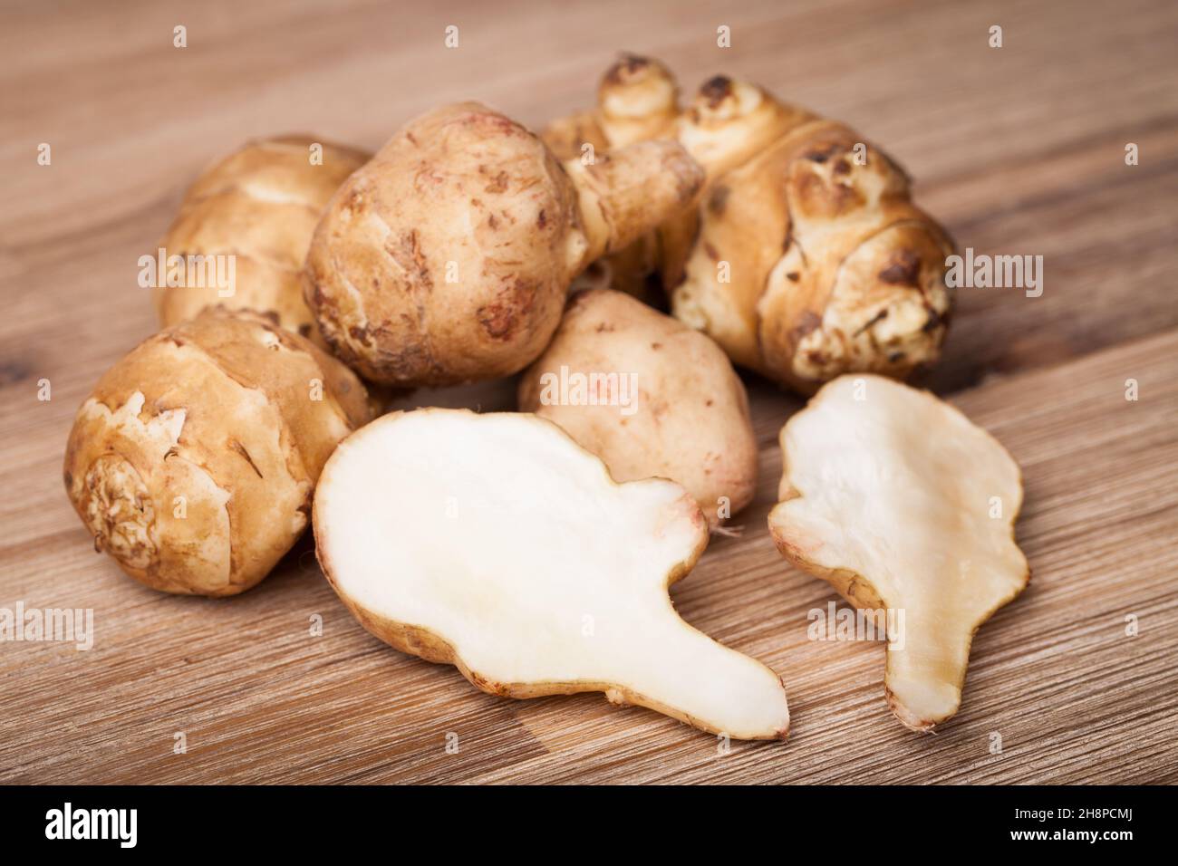 Jerusalem artichokes and cut entirely on wooden board Jerusalem ...