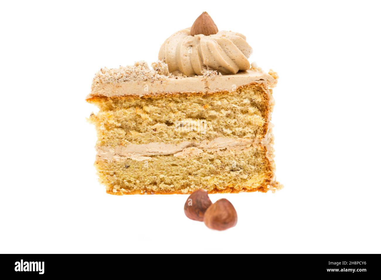 single tiny piece of nut cake with nuts in front isolated on white ...