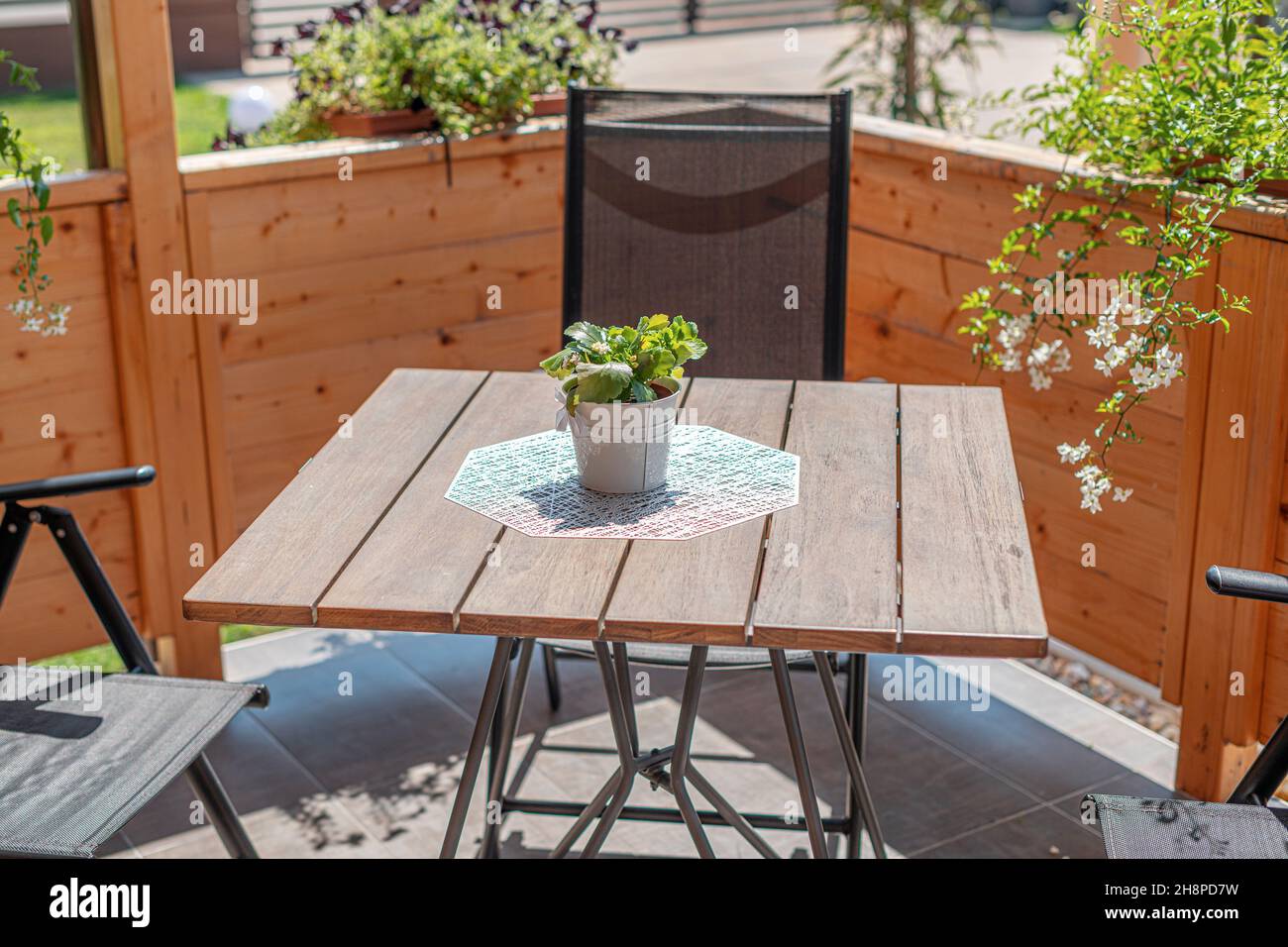 Wooden table on the terrace Stock Photo - Alamy