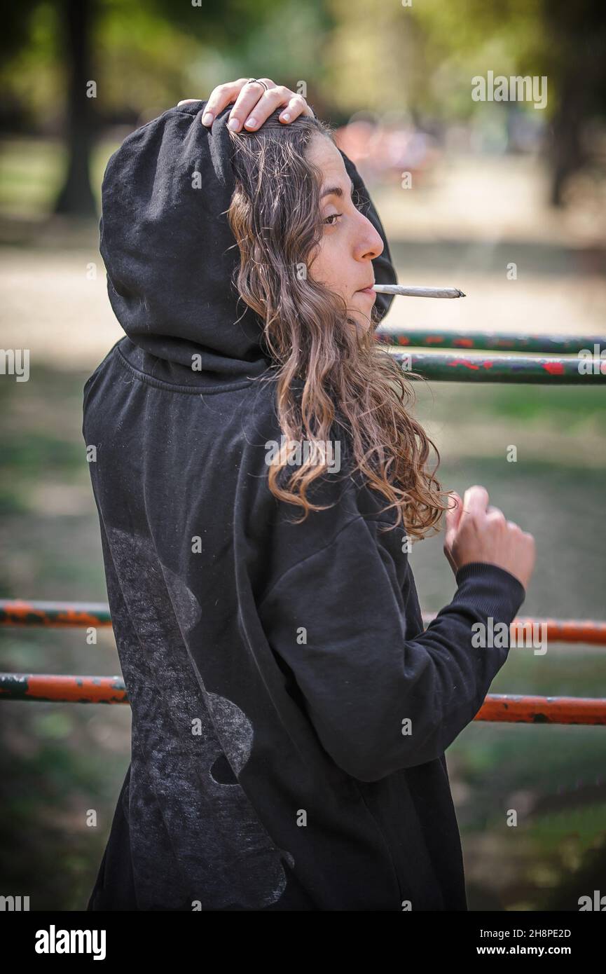 Closeup detail view of young woman smoke cannabis marijuana ganja or ...