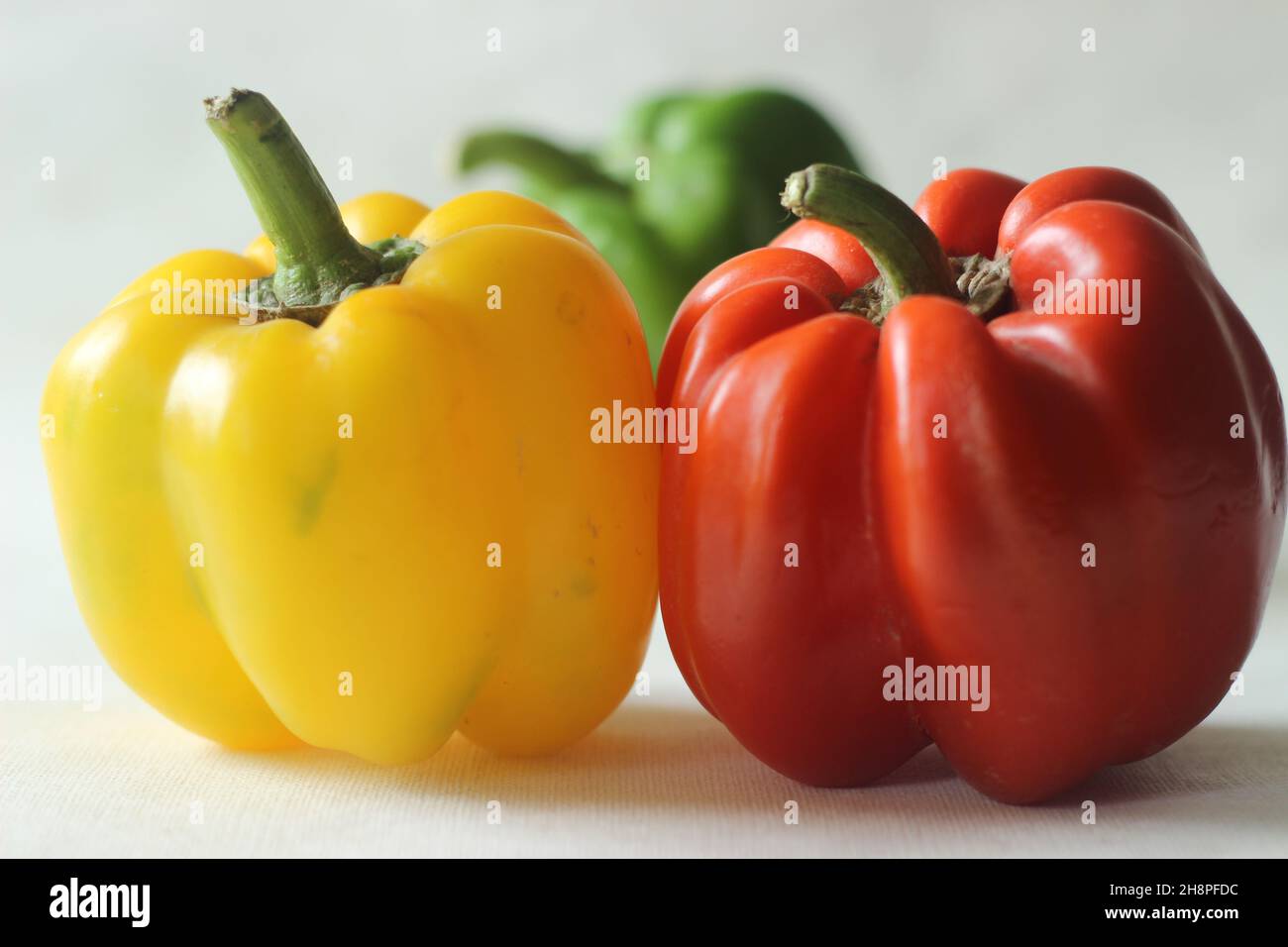 Red yellow and green bell peppers. Bell pepper or Capsicum annuum, also ...