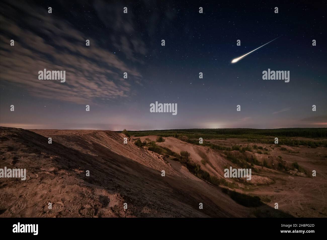 Meteor over sand hills and forest in moon light and starry sky. Long ...