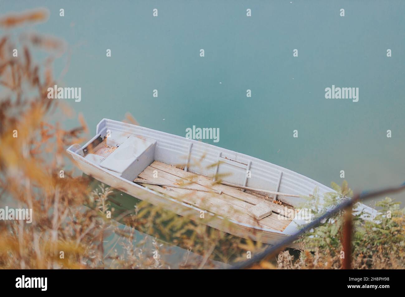 Small white boat in the lake Stock Photo - Alamy