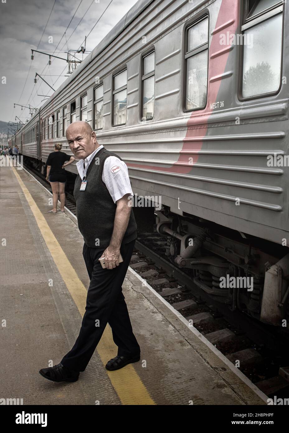 29th of July 2018, Russia, train conductor portrait by the train at the ...