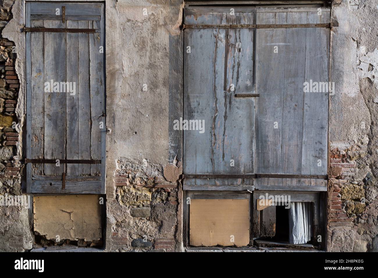 Old stone wall with wooden shutters Stock Photo - Alamy