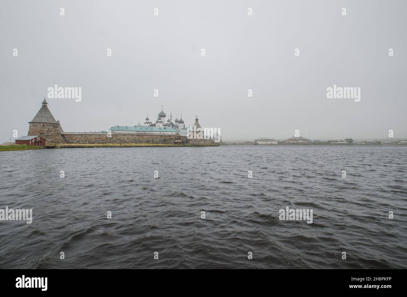 View of the Solovetsky Monastery and the stone fortress. Lake and fog ...