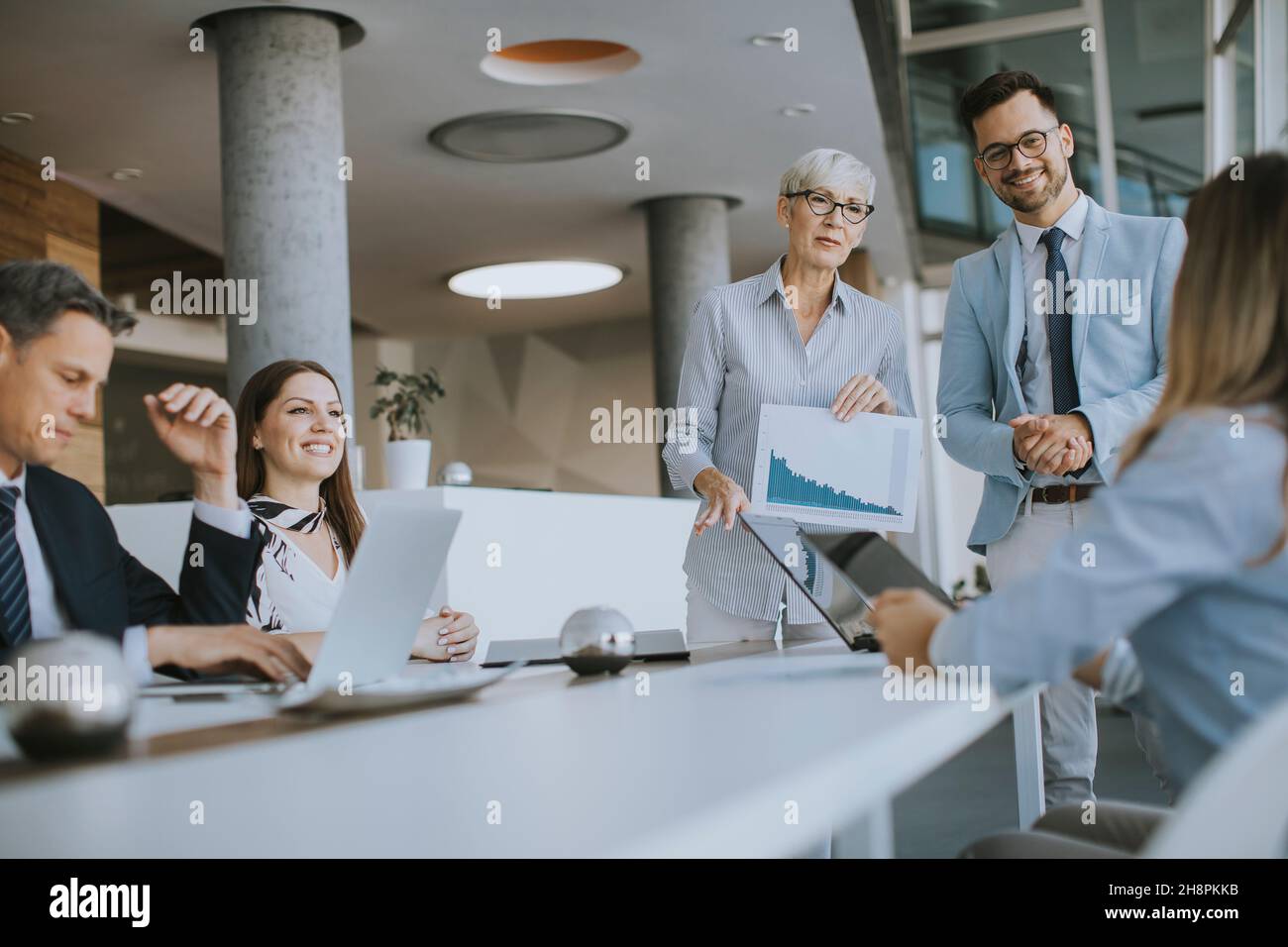 View at mature business woman explaining project details on a meeting ...
