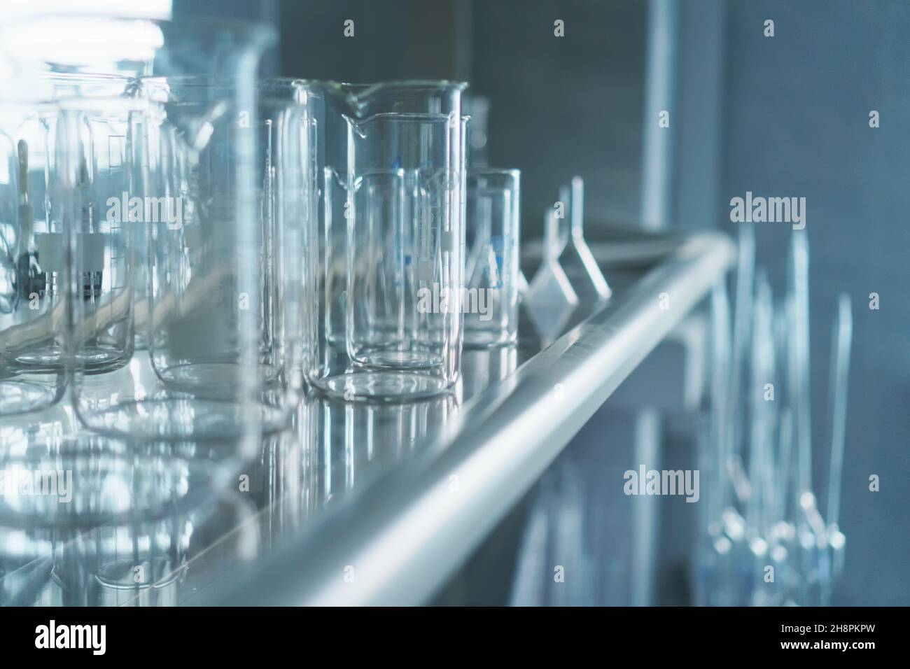 Laboratory glass flasks and test tubes on a rack. Research concept ...
