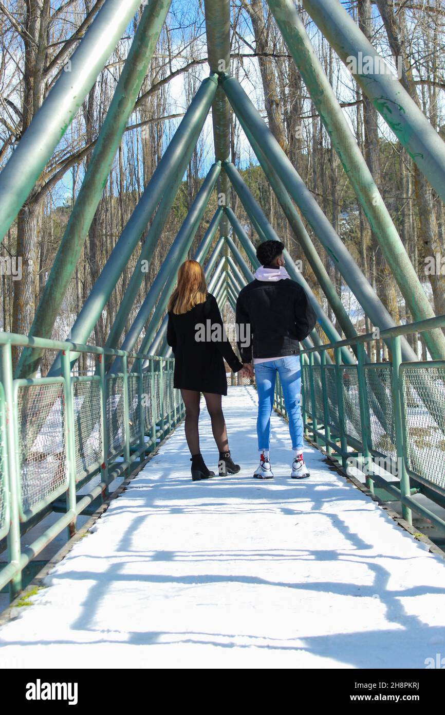 Young Caucasian couple tourists enjoying the scenery in snowy winter ...