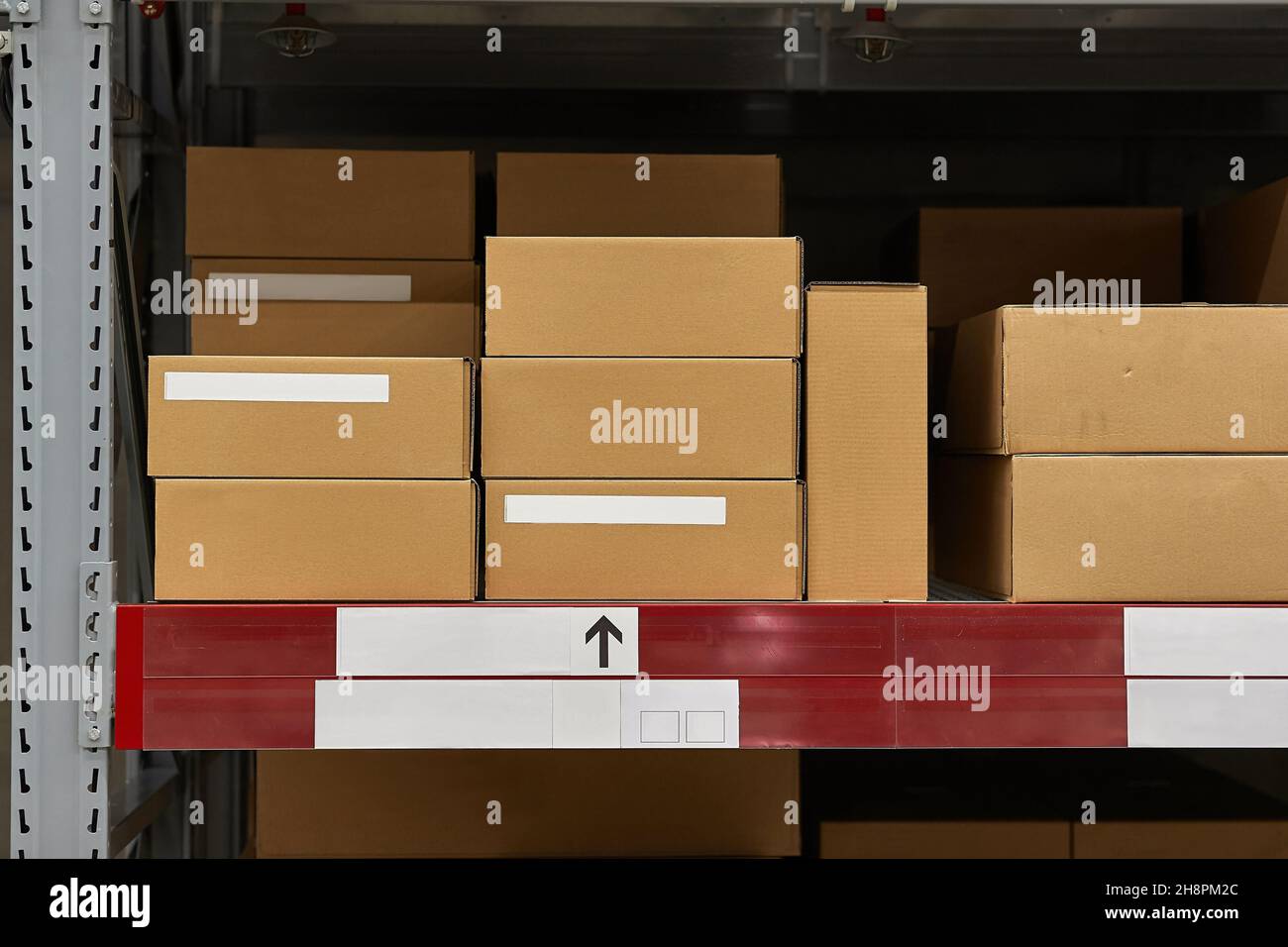Warehouse stocked with boxes in stacks Stock Photo - Alamy