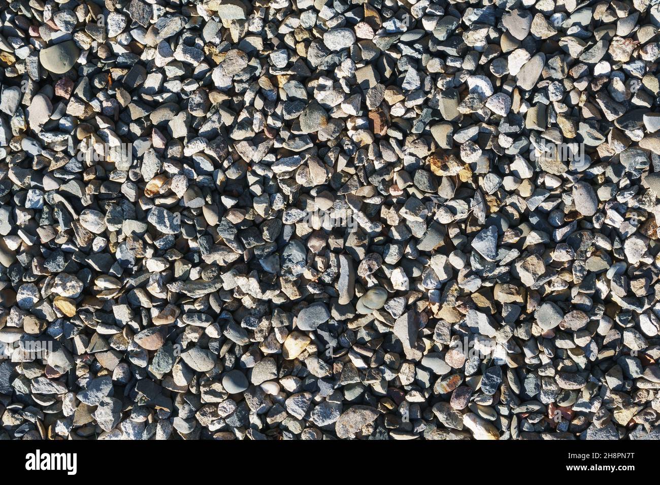 The texture of coarse gravel in full screen as a background. View from ...