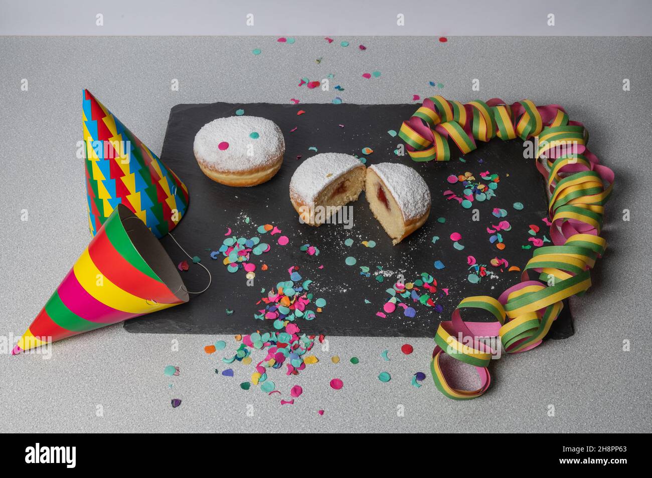 two Berlin carnival donuts with a festive decoration Stock Photo - Alamy