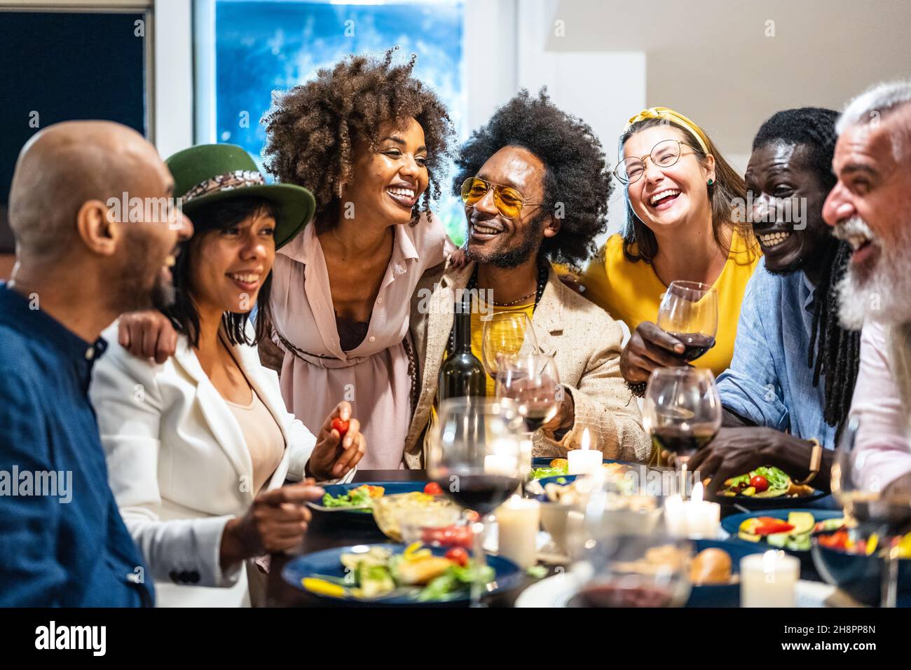 Different people of age and ethnicity eating a vegan dinner ...
