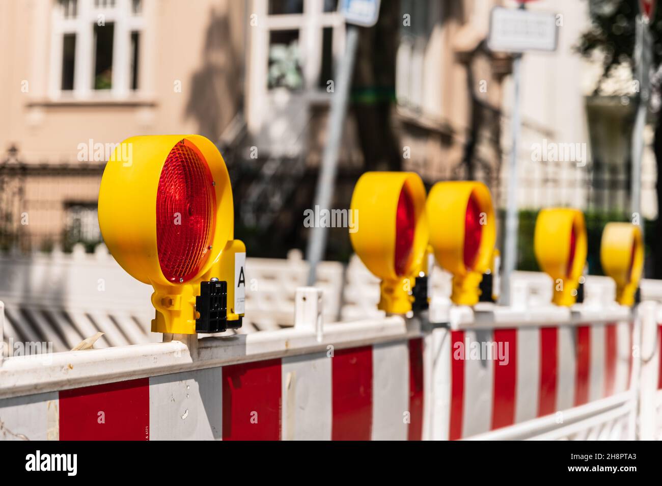 five red-colored hazard lights on a construction site barrier Stock ...