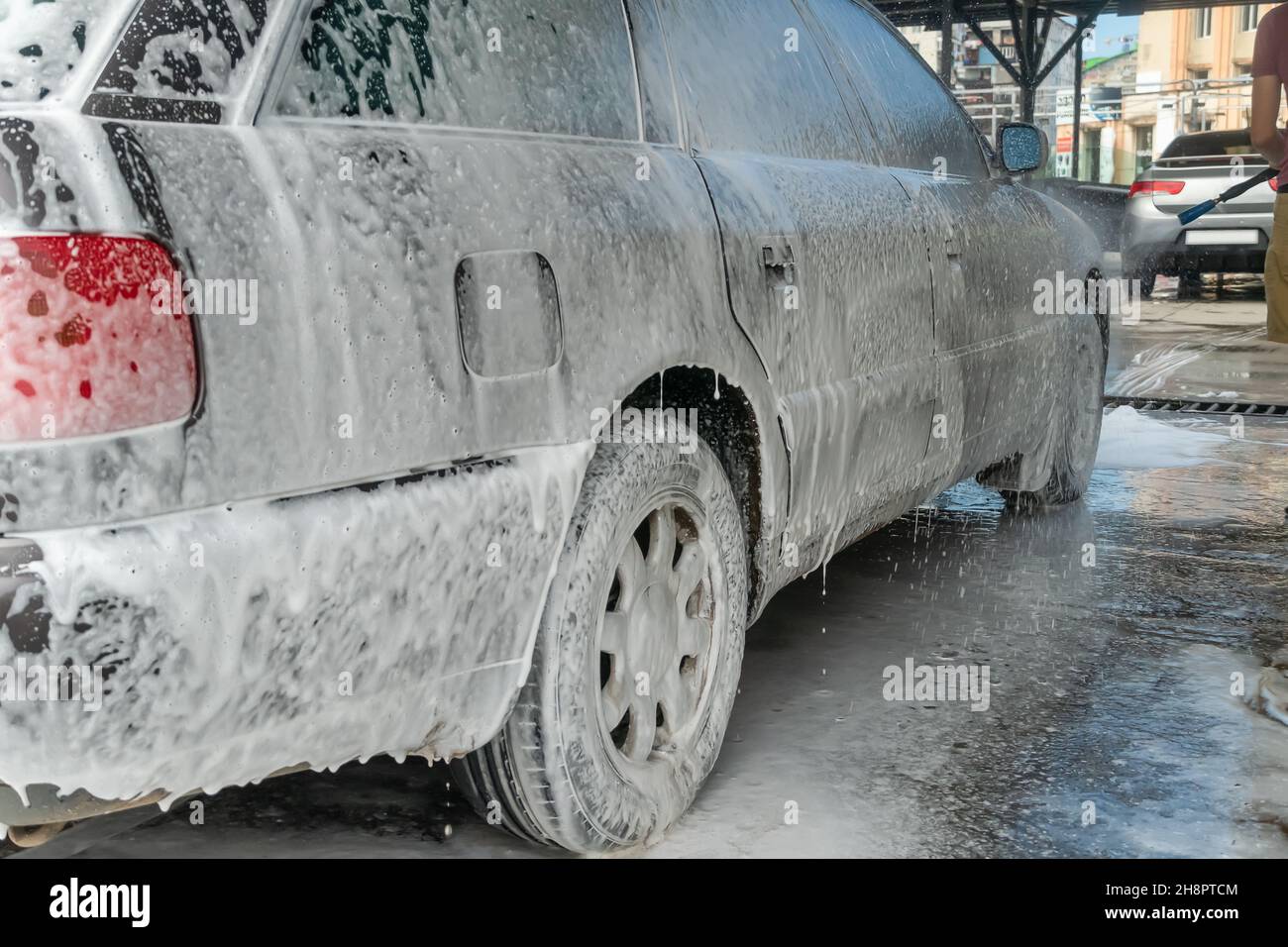 Gray car in white foam at a self-service car wash Stock Photo - Alamy